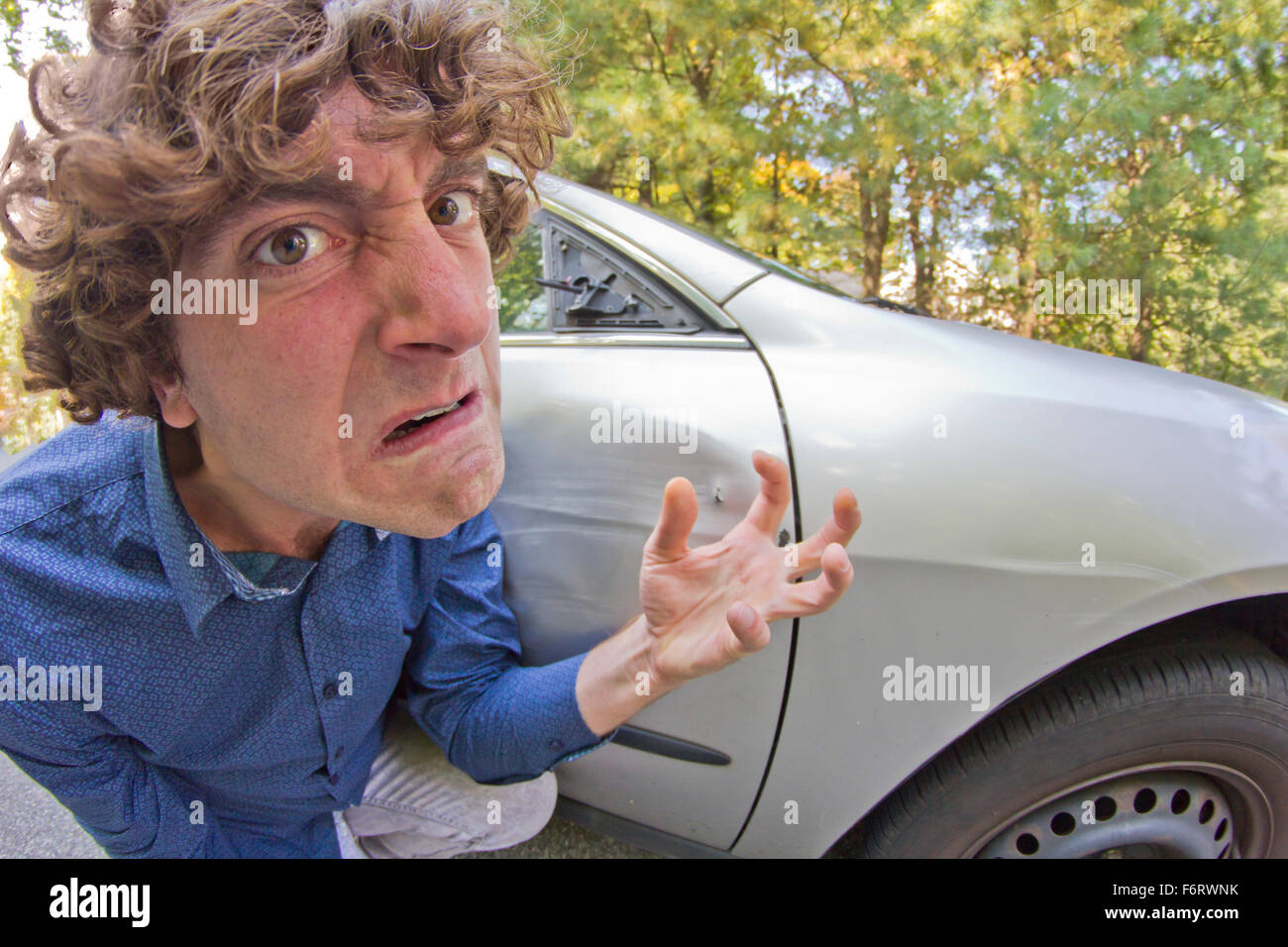 Silly man gets into car crash and makes ridiculous face Stock Photo - Alamy