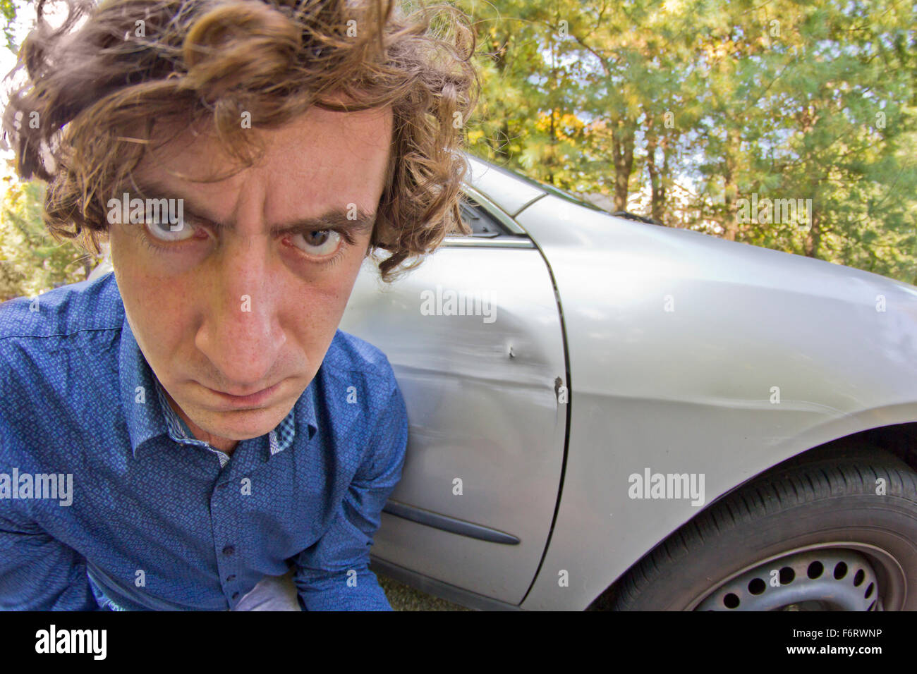 Silly man gets into car crash and makes ridiculous face Stock Photo - Alamy