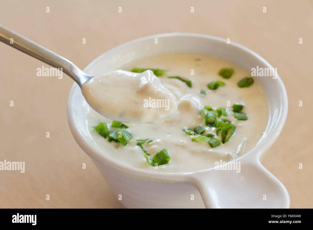 Creamy New England Clam Chowder garnished with green onion Stock Photo ...
