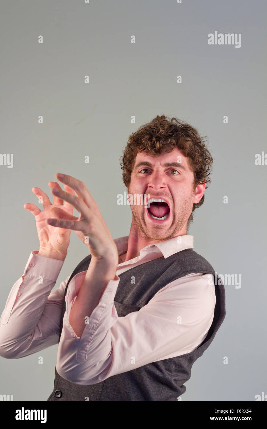 Man acting like an animal by growling snarling and clawing Stock Photo ...