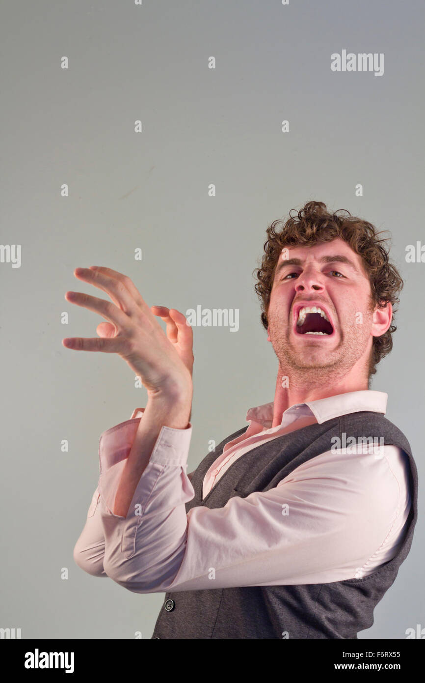 Man acting like an animal by growling snarling and clawing Stock Photo ...