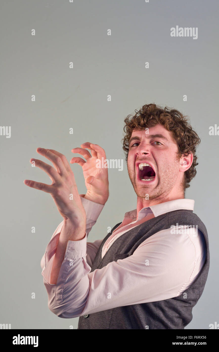Man acting like an animal by growling snarling and clawing Stock Photo ...