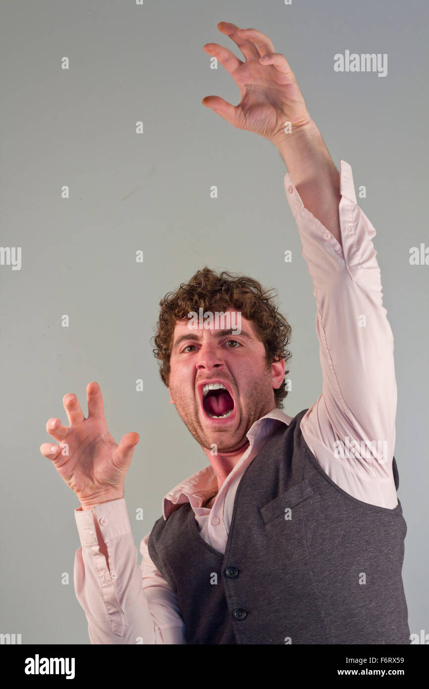 Man acting like an animal by growling snarling and clawing Stock Photo ...