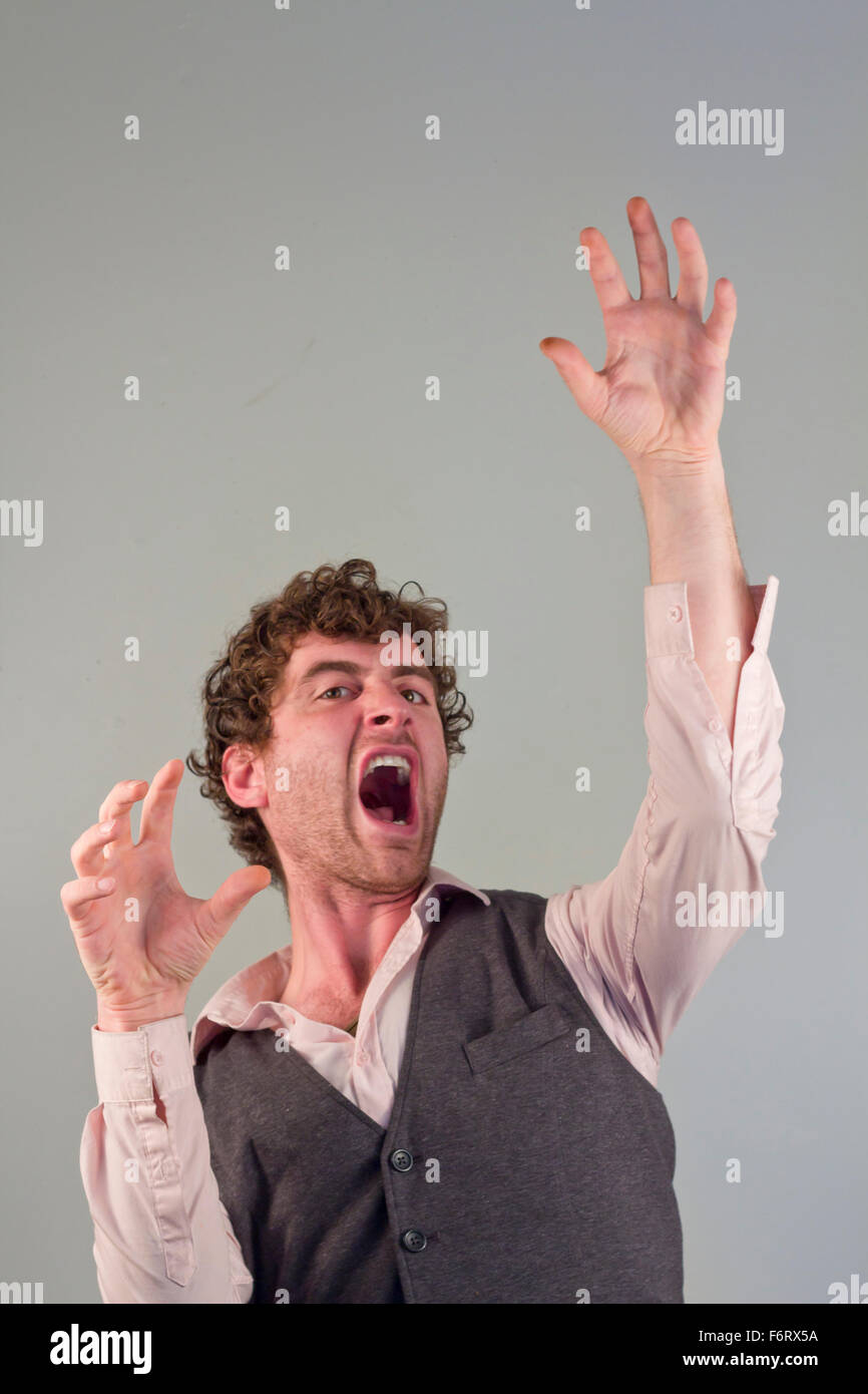 Man acting like an animal by growling snarling and clawing Stock Photo ...