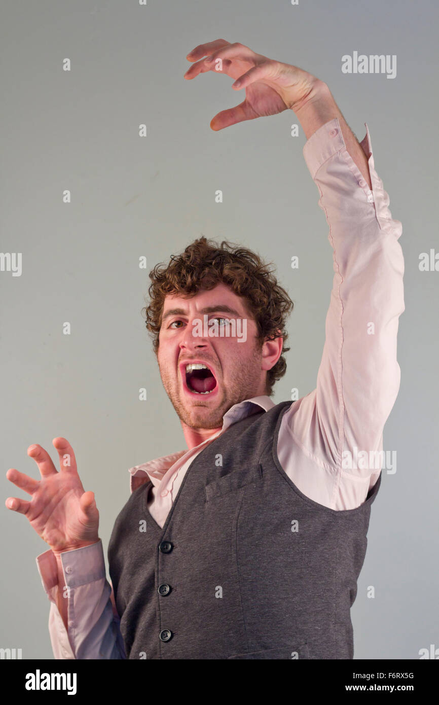 Man acting like an animal by growling snarling and clawing Stock Photo ...