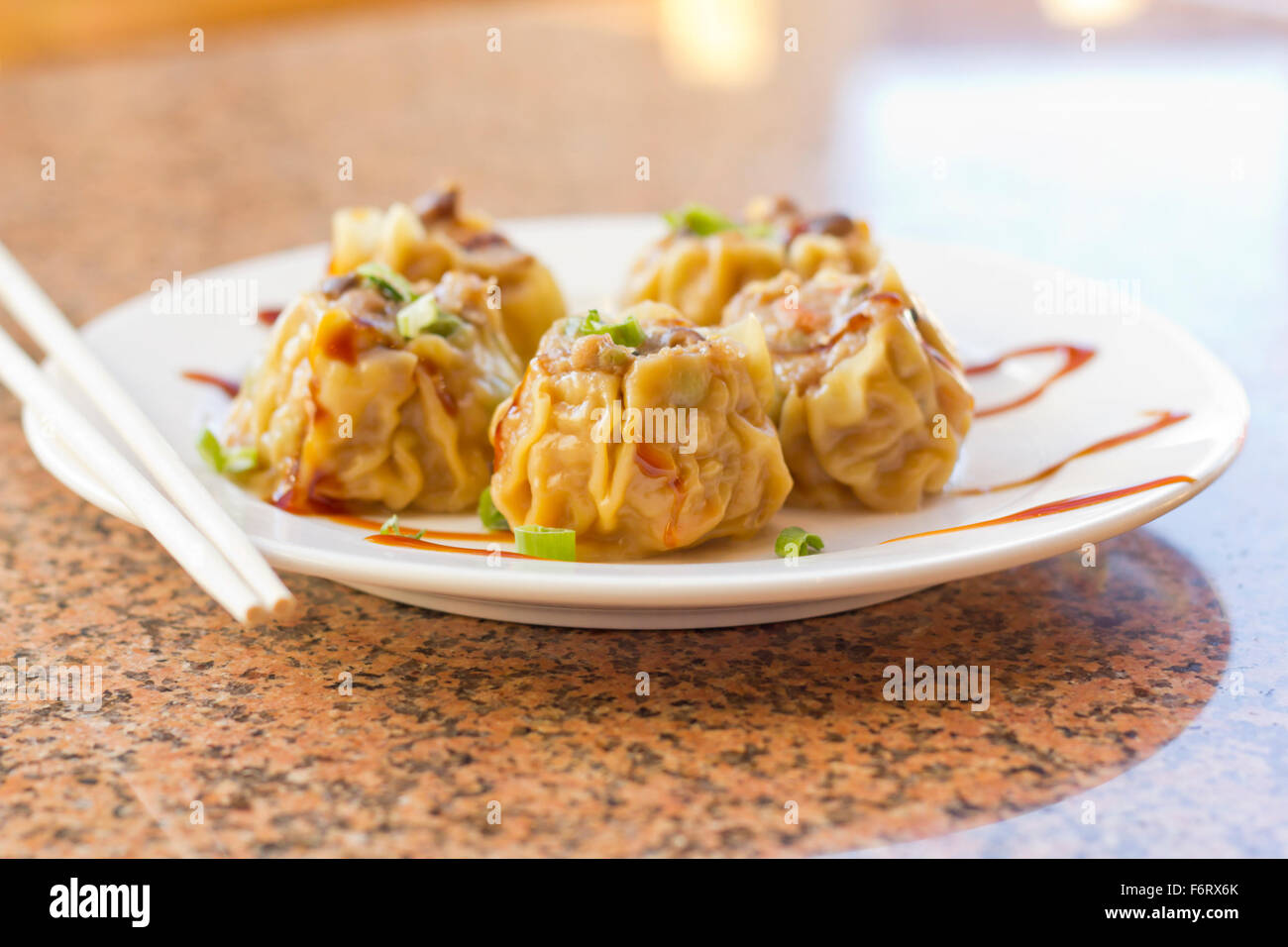 Delicious Chinese Dim Sum dumplings topped with scallions and sweet ...
