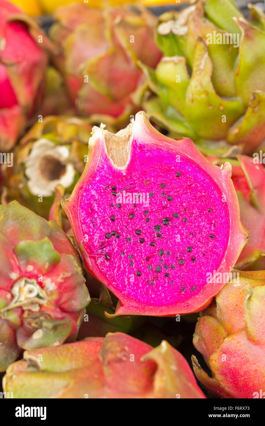Juicy exotic sliced pink dragonfruit on display at local farmers market ...