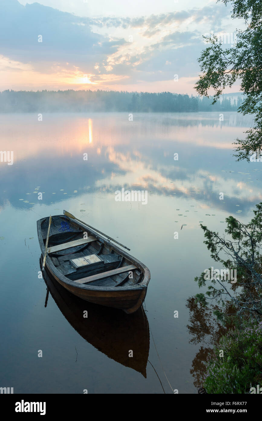 Rowboat on calm lake Stock Photo - Alamy