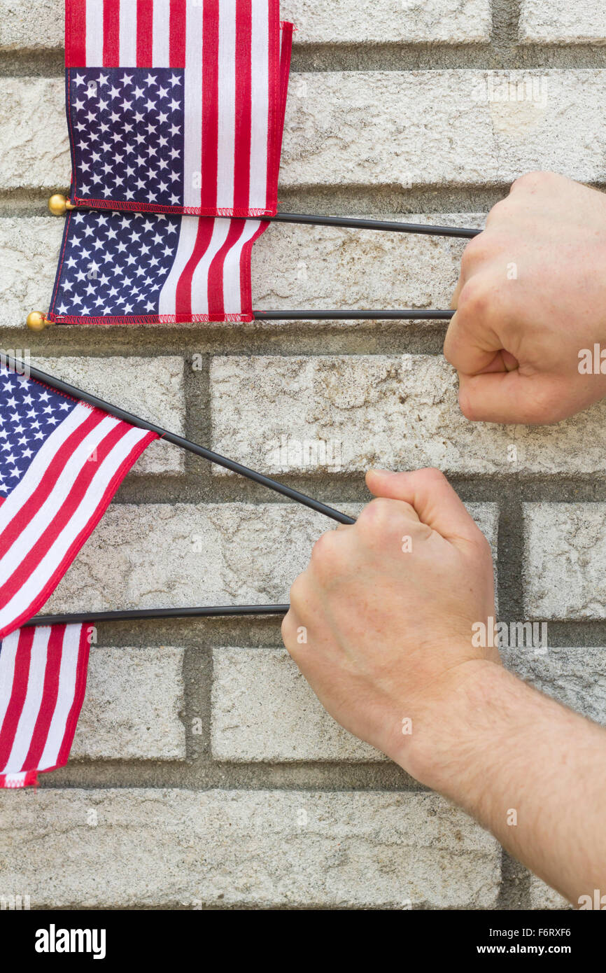 Fists clench small American flags in patriotic imagery Stock Photo - Alamy