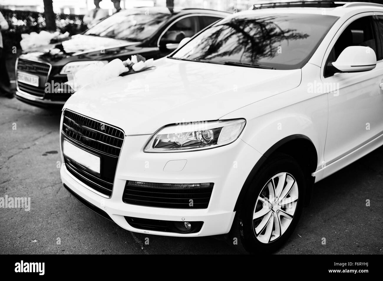 wedding courtege of two black and white cars Stock Photo - Alamy