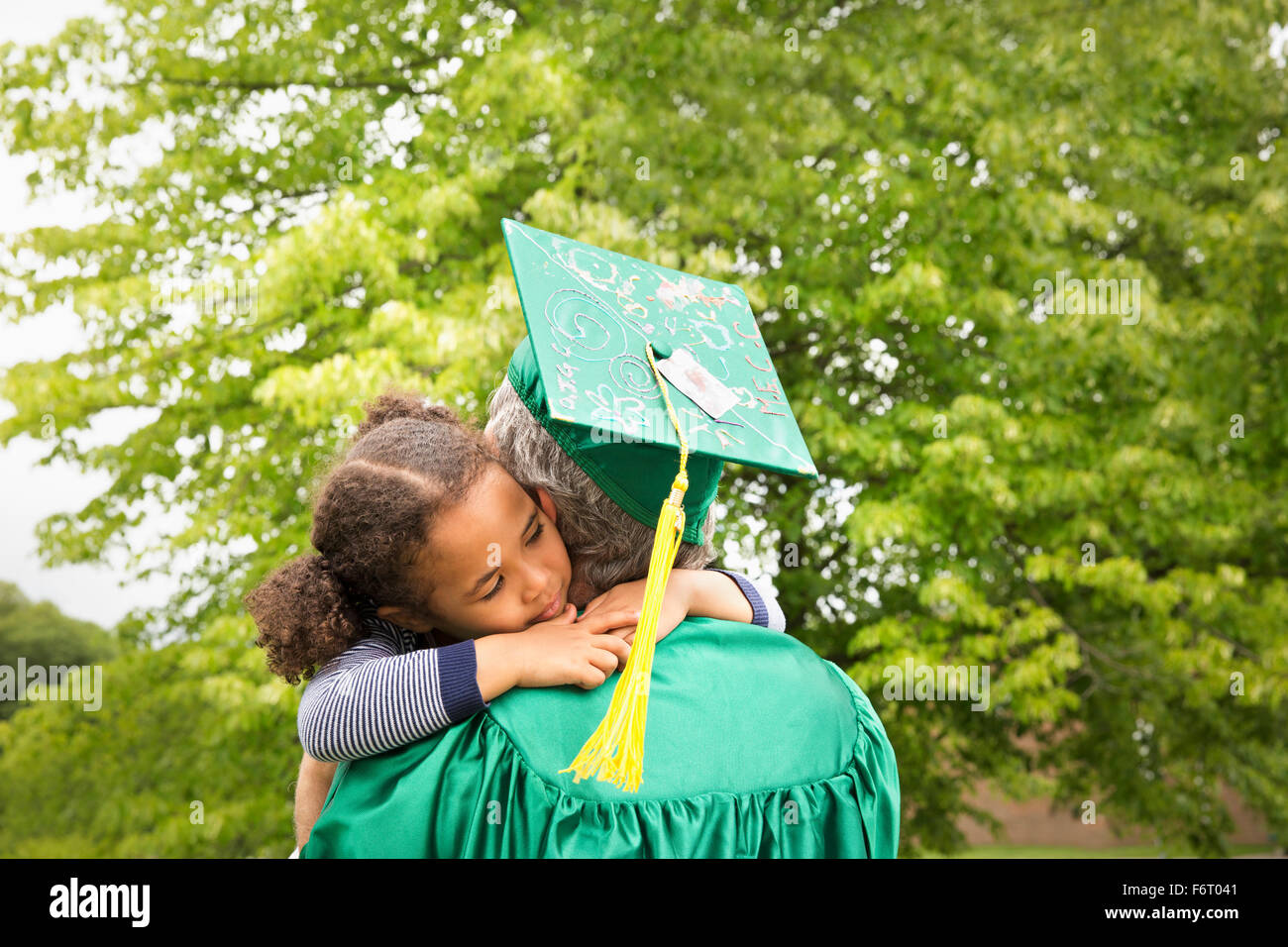 College graduate father hugging daughter Stock Photo - Alamy