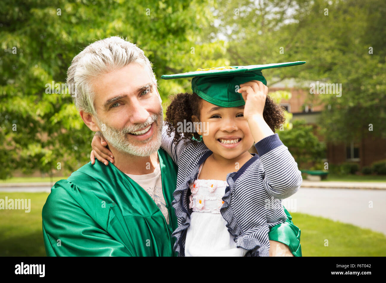 College graduate father holding daughter Stock Photo - Alamy