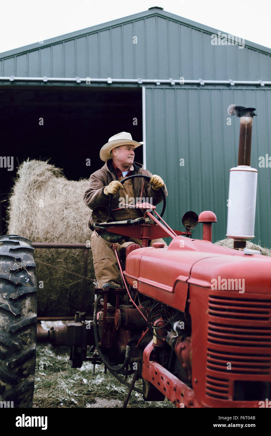 Caucasian farmer driving tractor on farm Stock Photo - Alamy