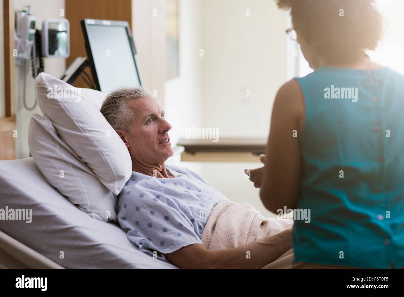 Doctor talking to patient in hotel room Stock Photo - Alamy