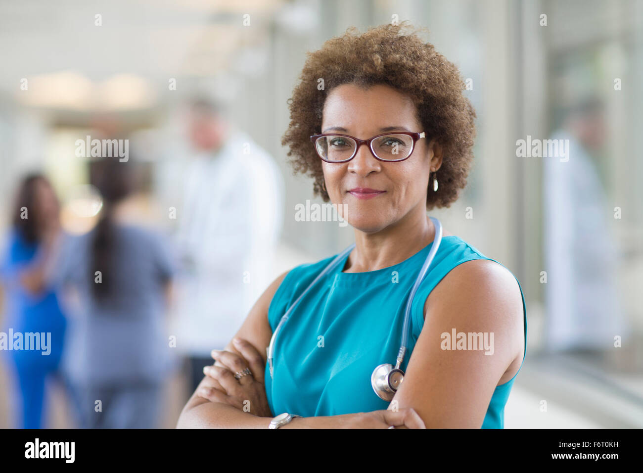 Smiling black doctor working hi-res stock photography and images - Alamy