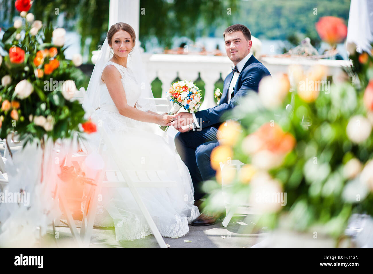 happy fashionable wedding couple on wedding ceremony of registration ...