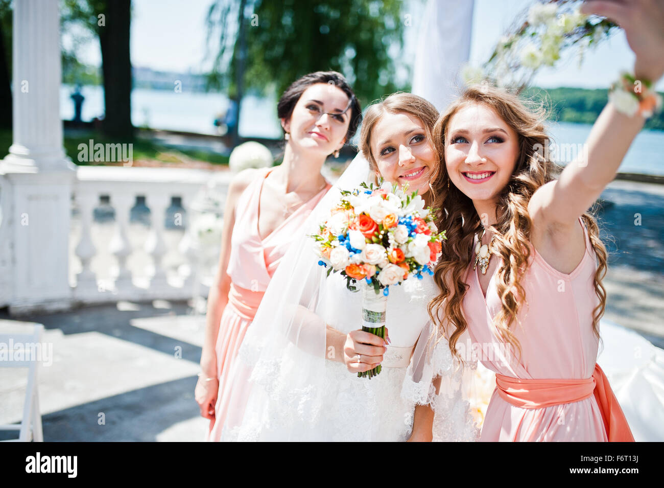 bride with bridesmaid at wedding ceremony doing selfie Stock Photo - Alamy
