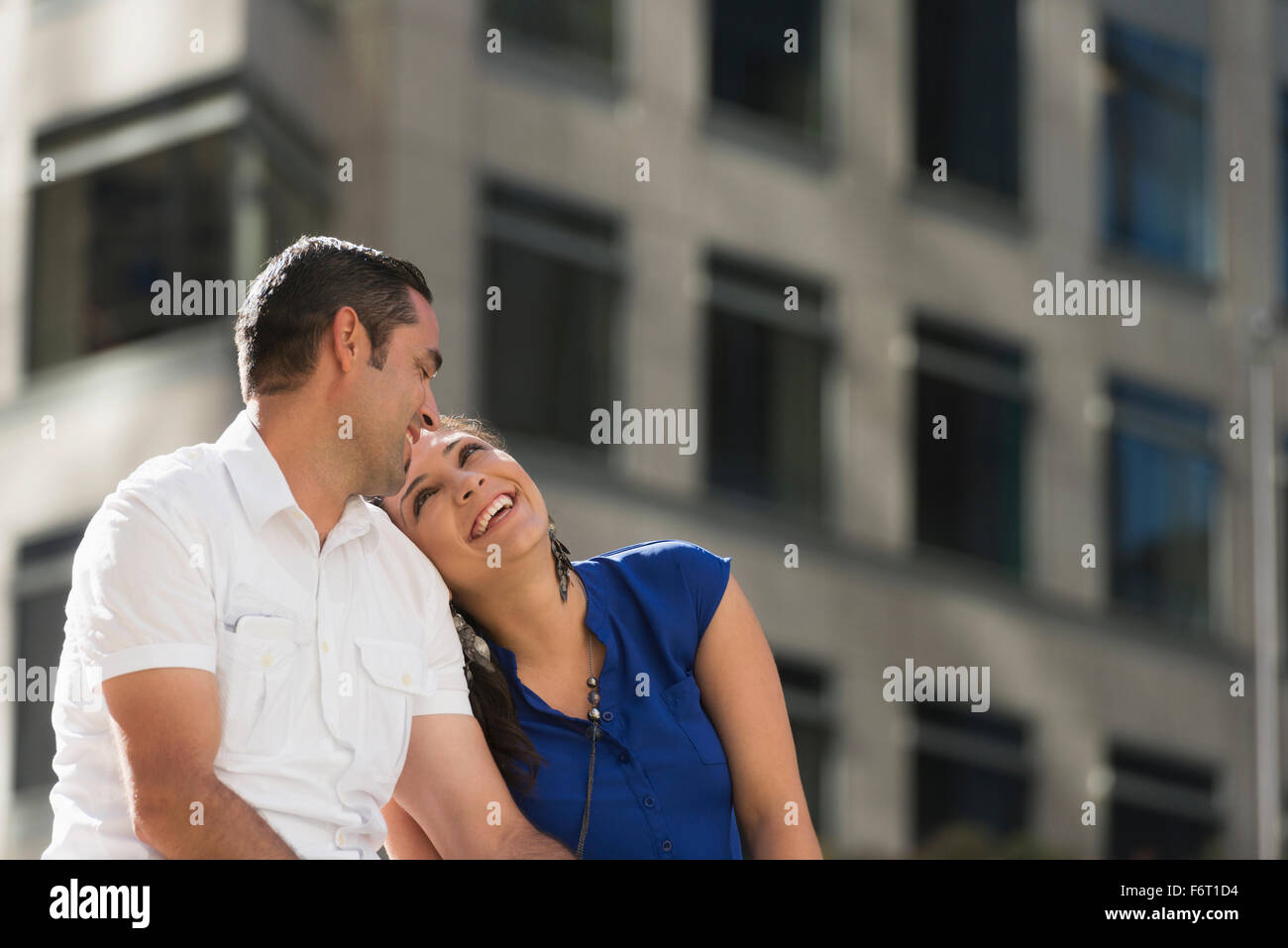 Hispanic couple hugging in city Stock Photo - Alamy