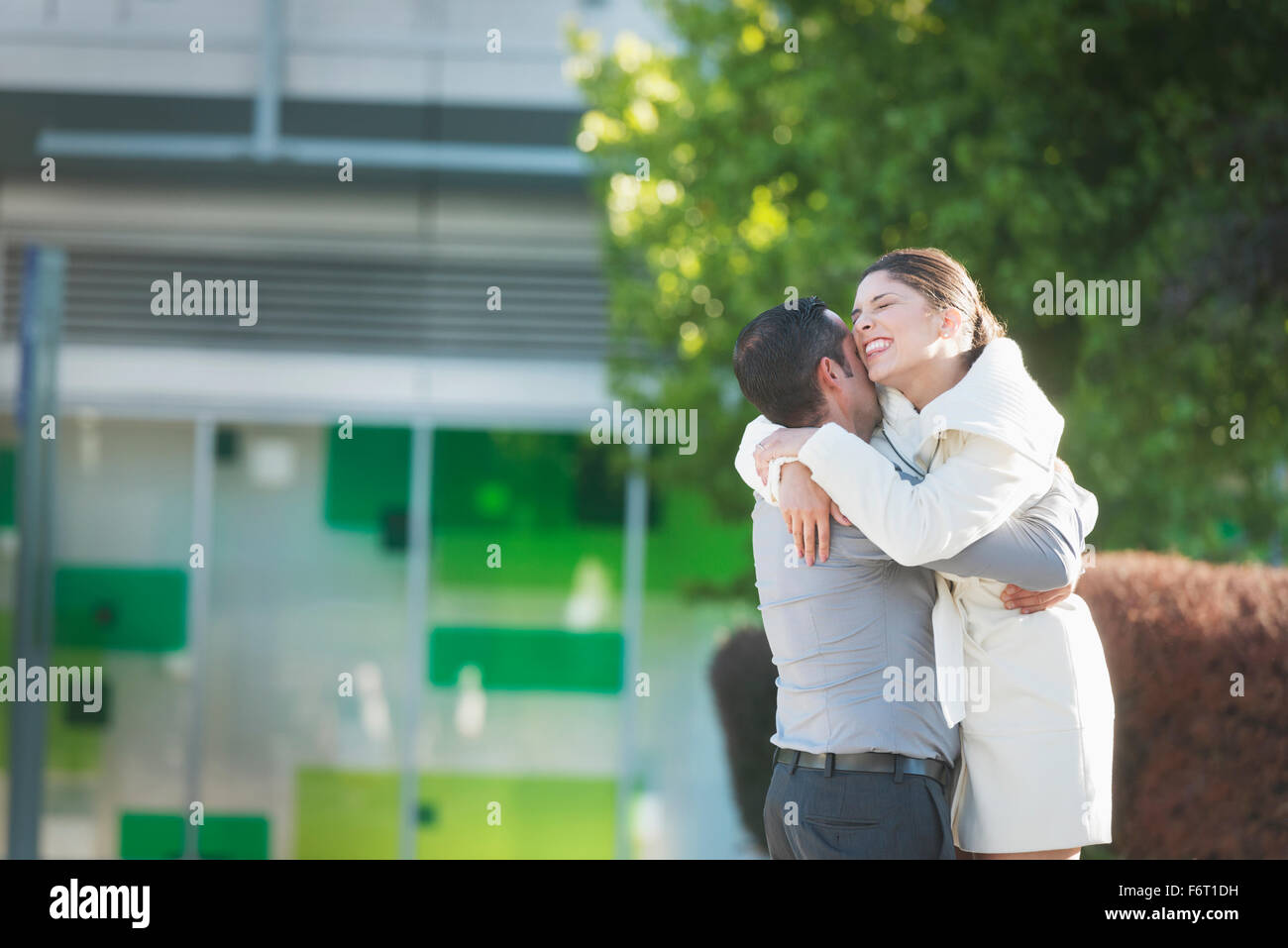 Hispanic couple hugging in city Stock Photo - Alamy