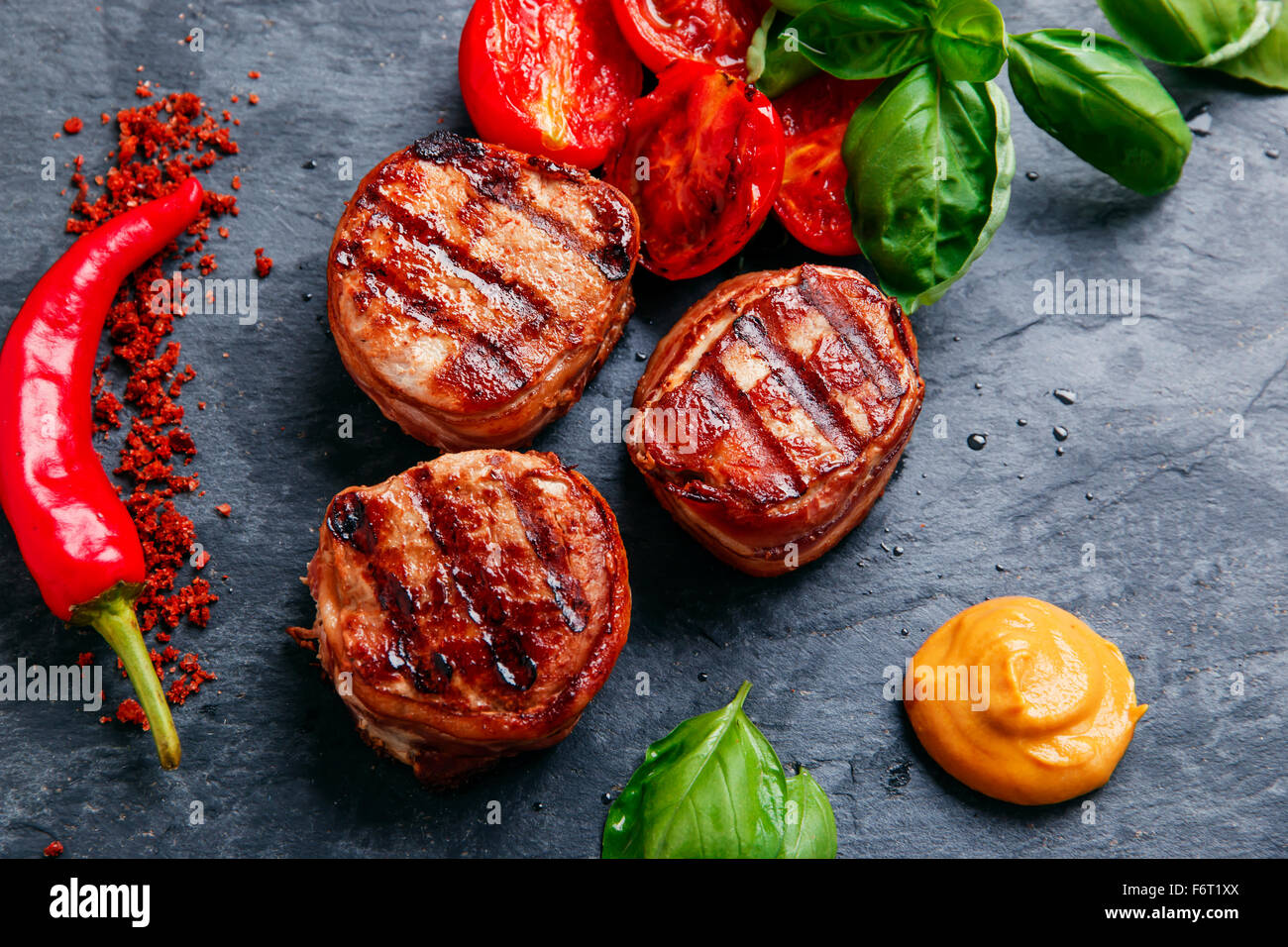 Grilled meat fillet steak wrapped in bacon medallions Stock Photo - Alamy