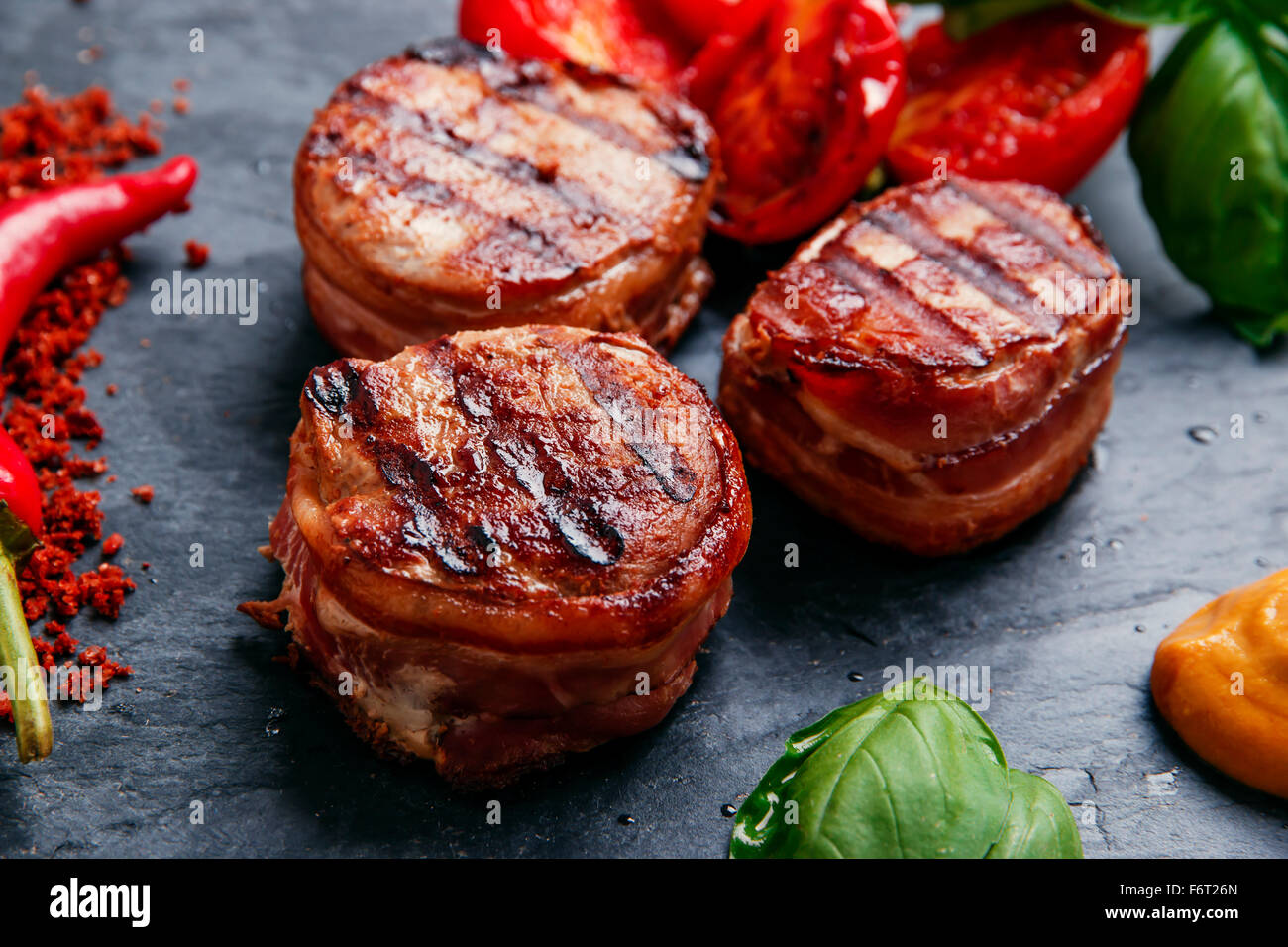 Grilled meat fillet steak wrapped in bacon medallions Stock Photo - Alamy