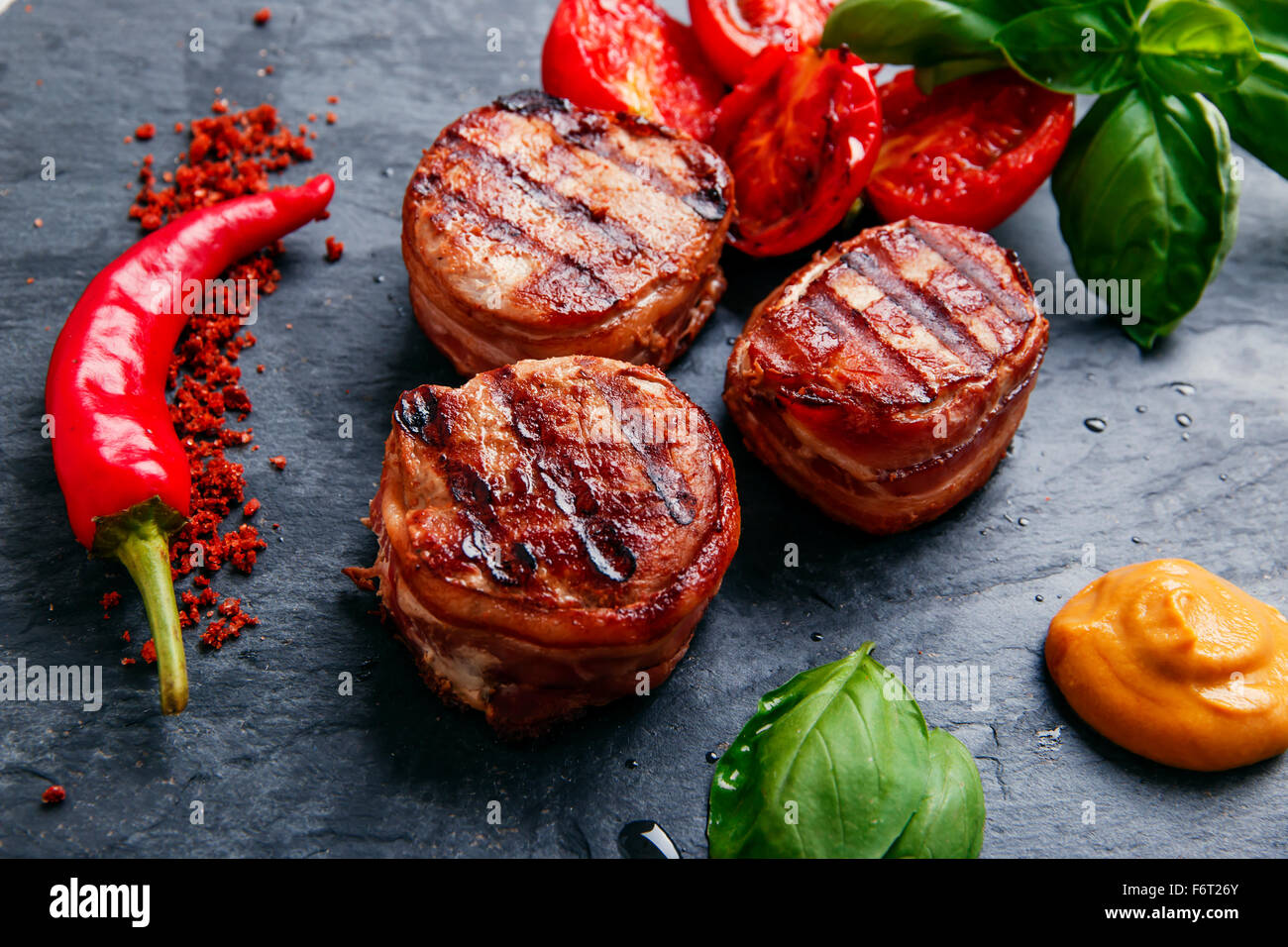 Grilled meat fillet steak wrapped in bacon medallions Stock Photo - Alamy