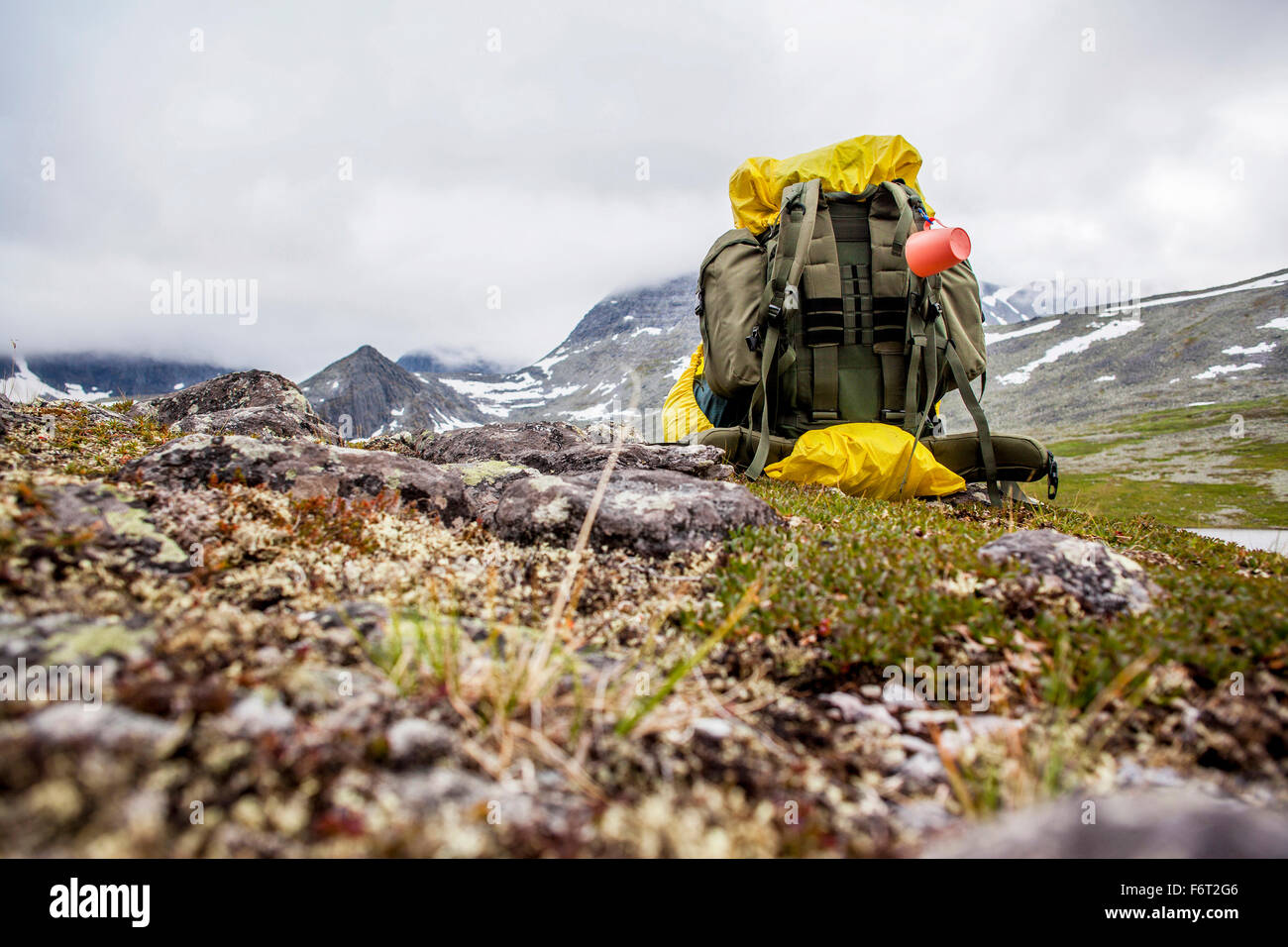 Backpack in mountain field Stock Photo - Alamy