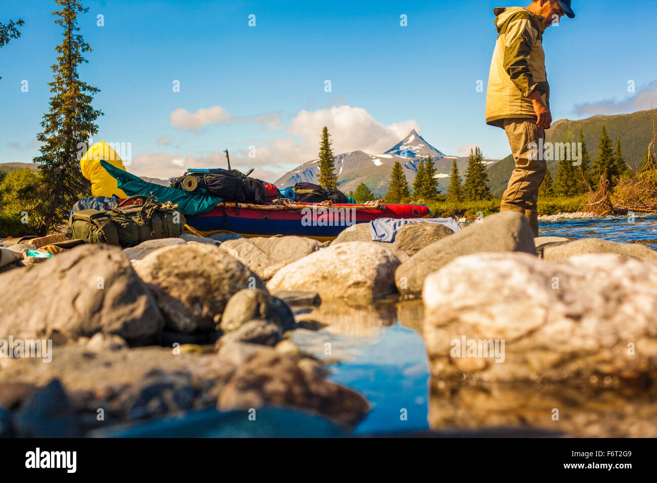 Mari hiker standing on rocks in remote river Stock Photo - Alamy