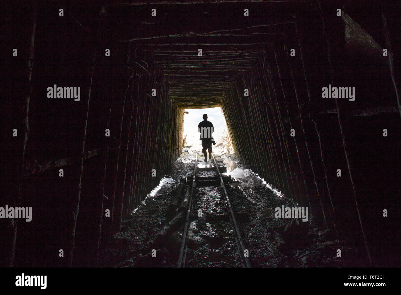 Mari man walking on tracks in mine Stock Photo - Alamy