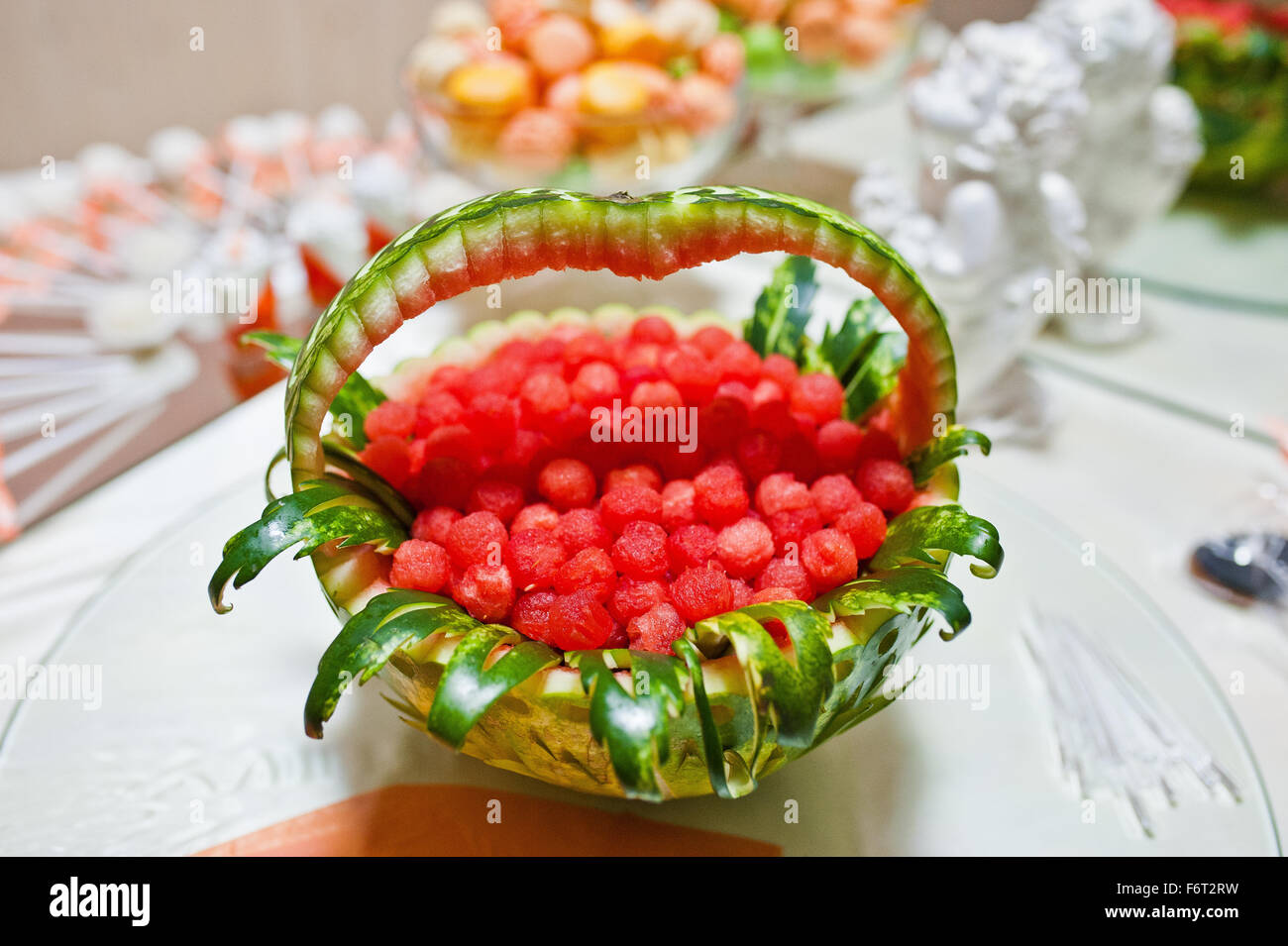 decorated watermelon with candies and other sweets on wedding reception ...