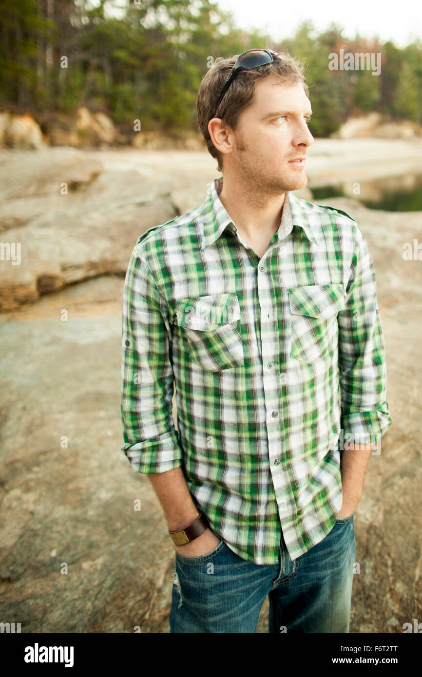 Man standing on rocks Stock Photo - Alamy