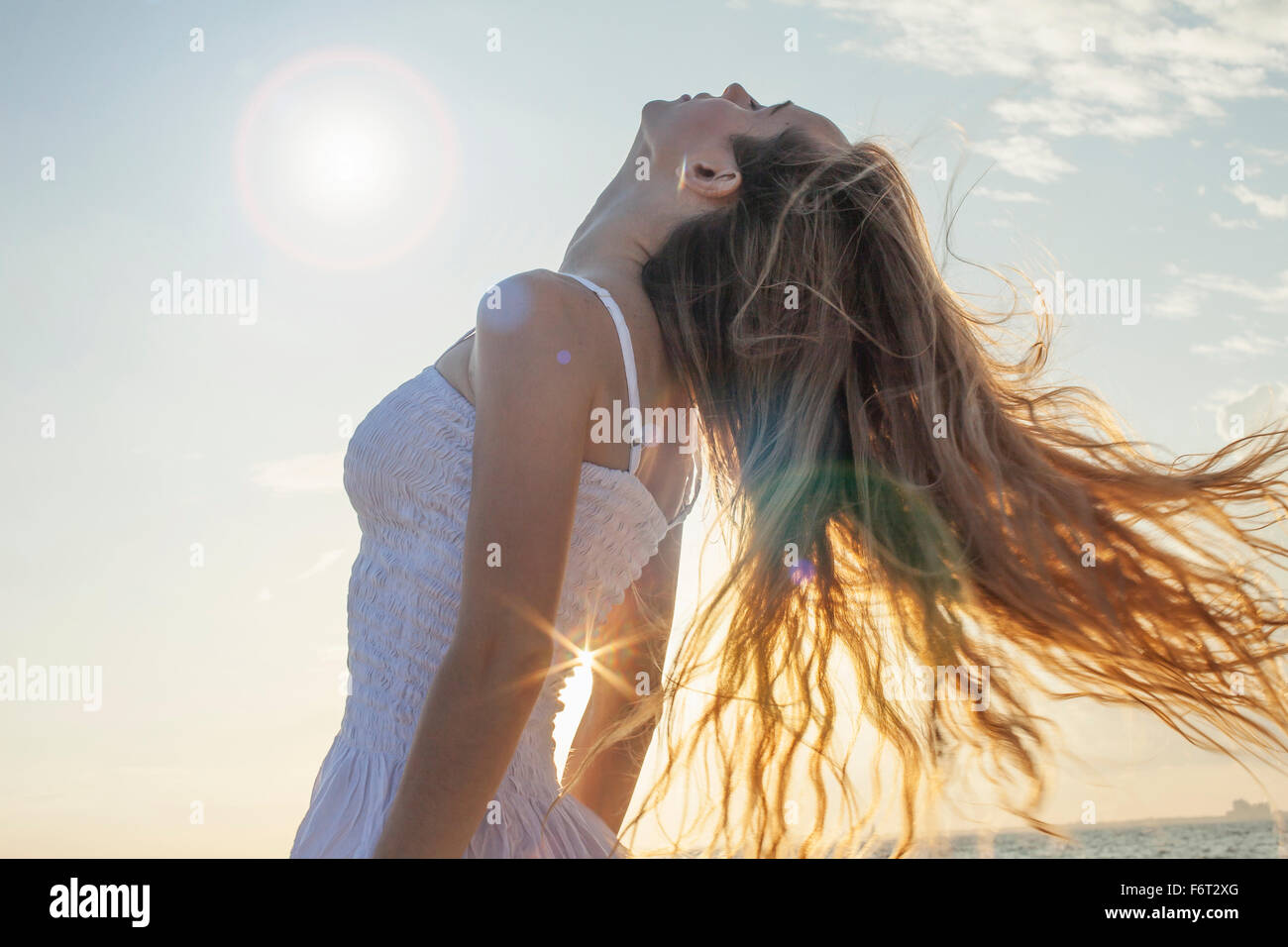 Caucasian woman tossing her hair outdoors Stock Photo - Alamy