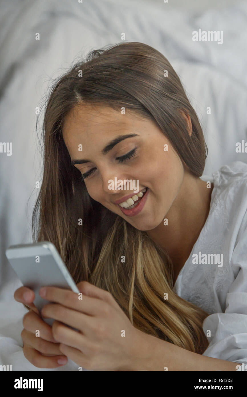 Cell phone in bed hi-res stock photography and images - Alamy