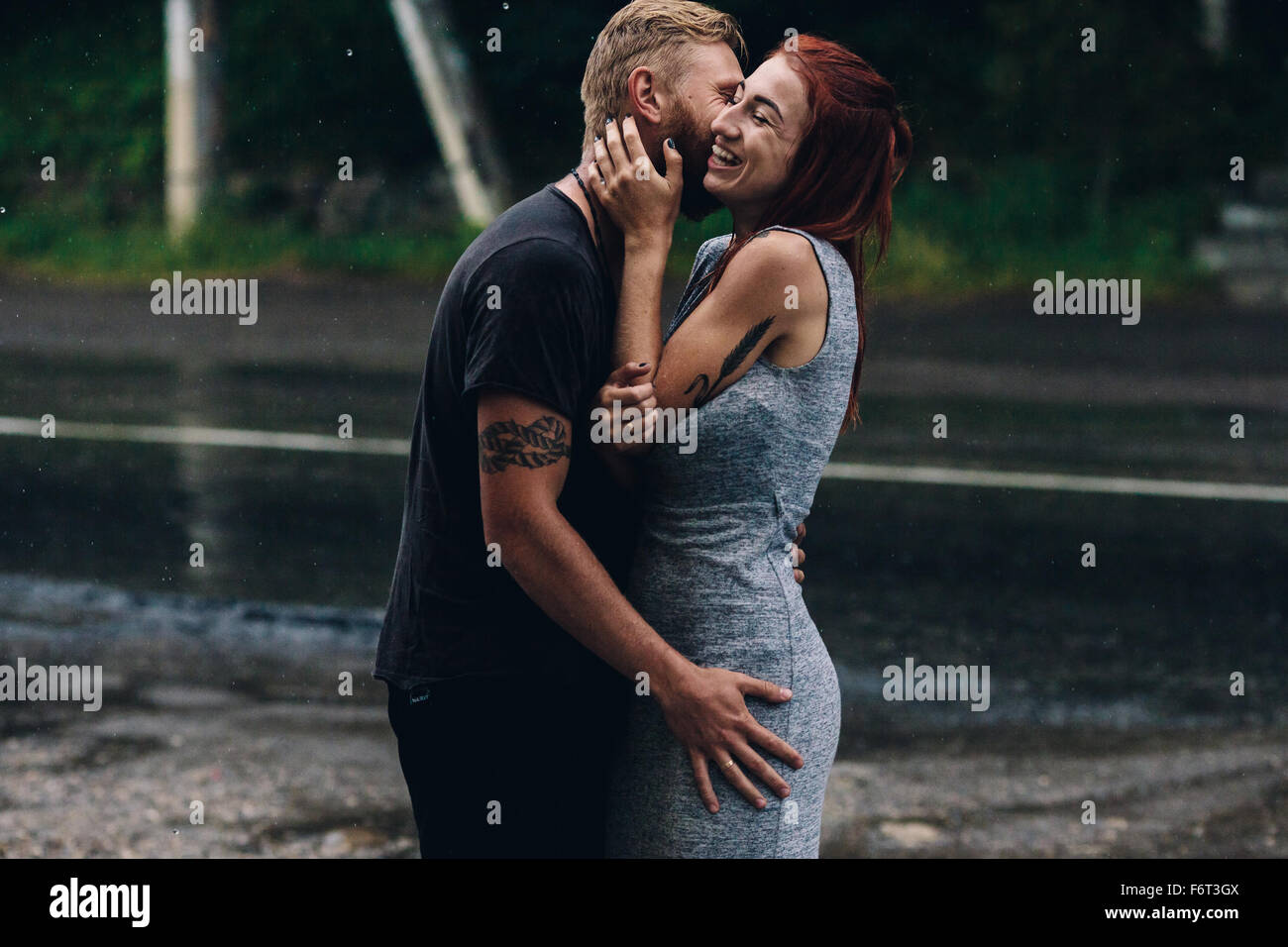 beautiful couple hugging in the rain Stock Photo - Alamy