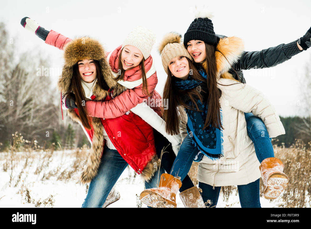 Caucasian girls playing in snow Stock Photo - Alamy
