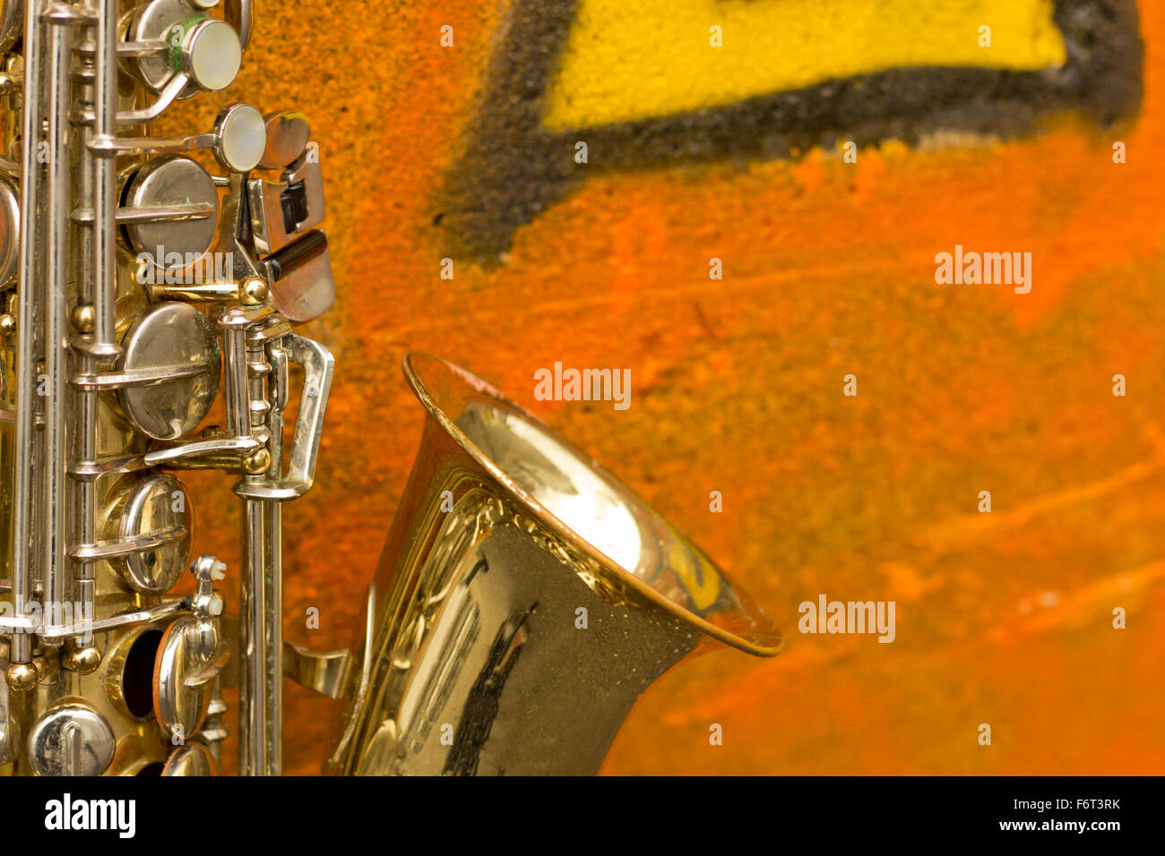 Lone old saxophone leans against brick wall outside abandoned jazz club ...