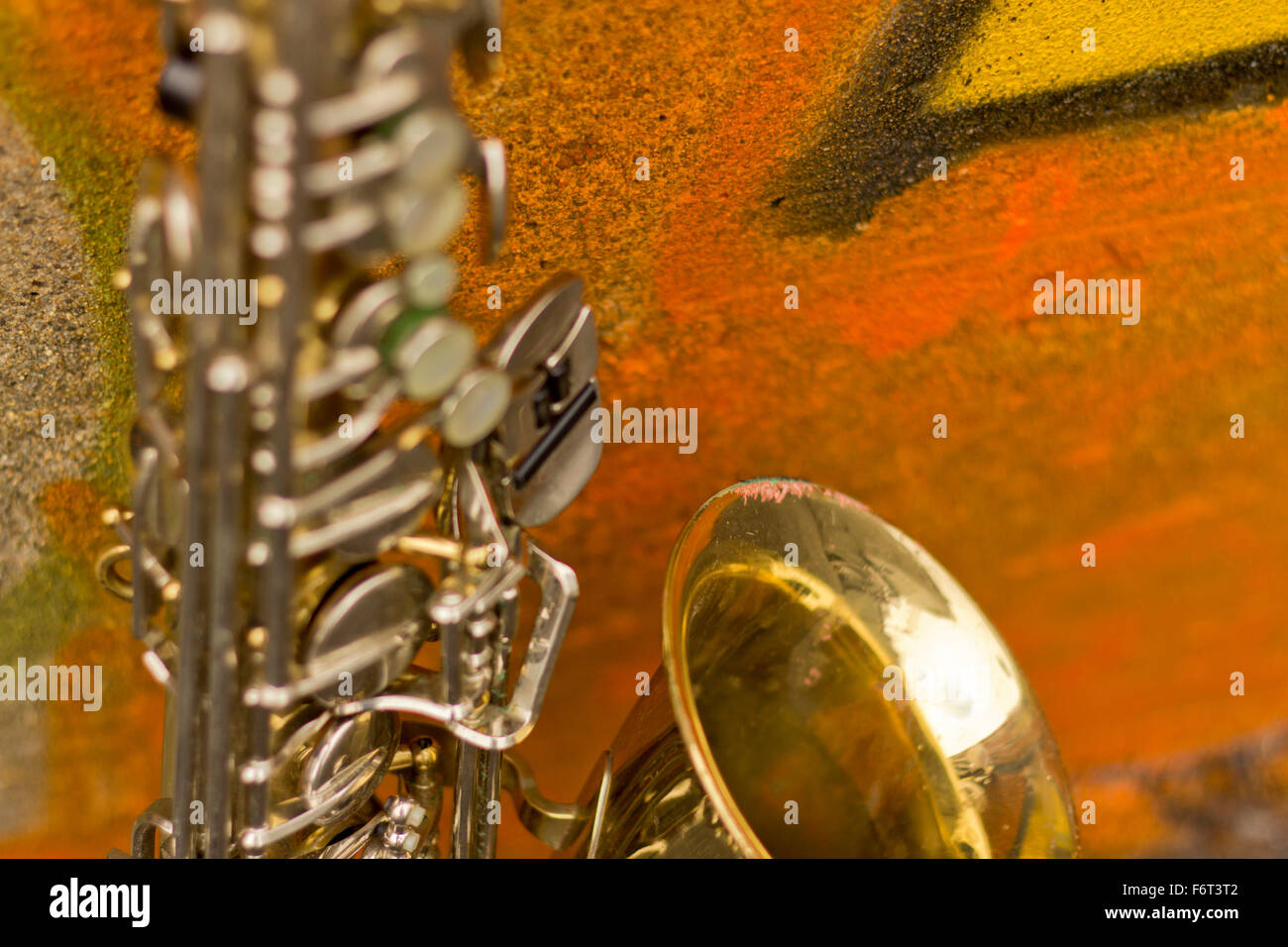 Lone old saxophone leans against brick wall outside abandoned jazz club ...