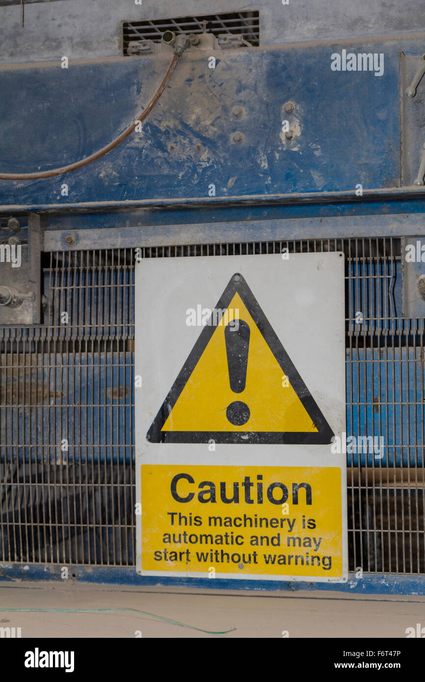 A warning sign cautioning that a machine may start automatically Stock ...