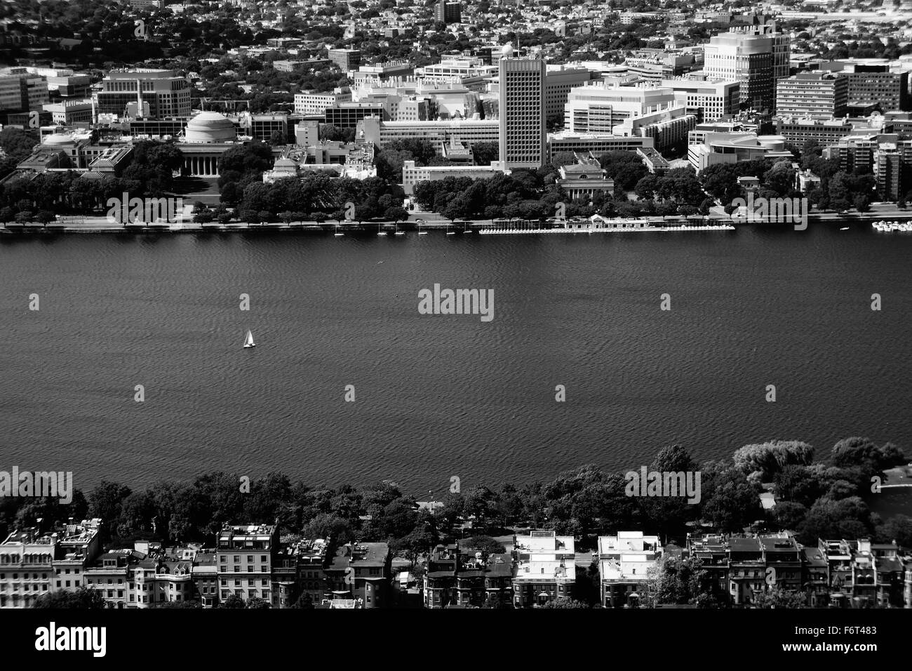 A sailboat on Charles River, with MIT in the background, black & white ...