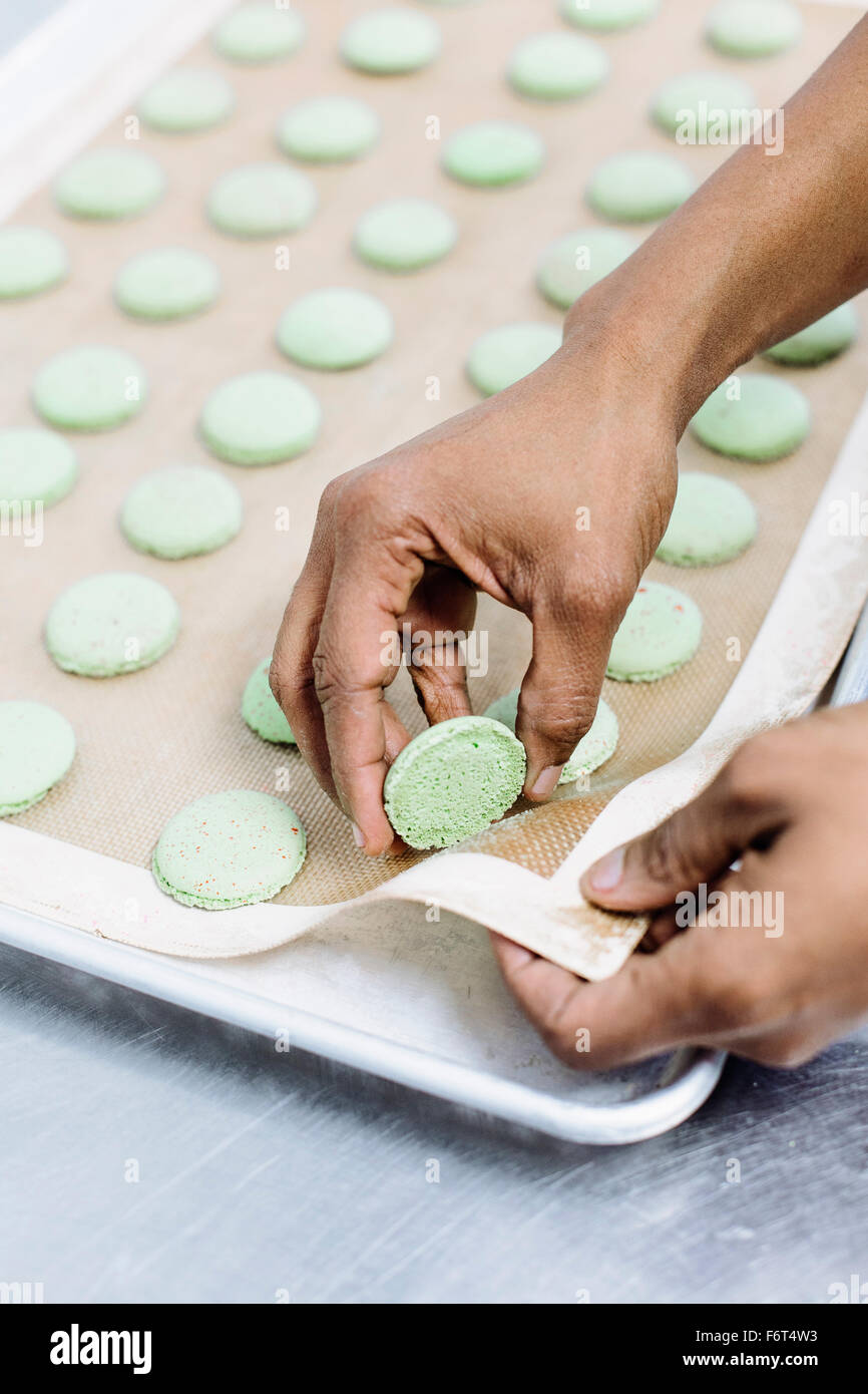 Close up of baker peeling cookies from tray Stock Photo - Alamy