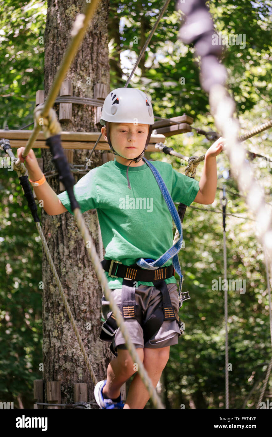 Caucasian boy balancing on rope bridge Stock Photo - Alamy