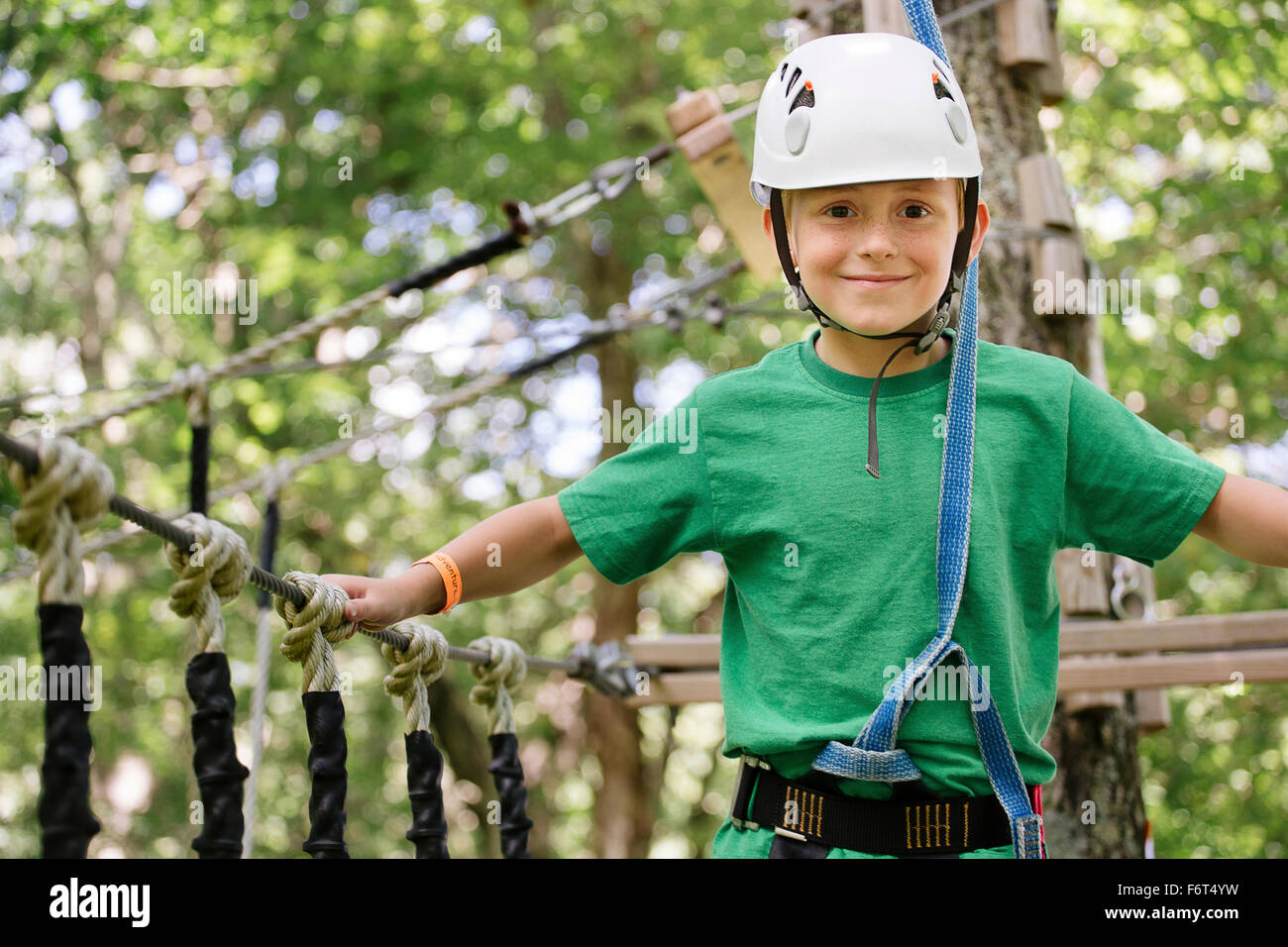 Caucasian boy balancing on rope bridge Stock Photo - Alamy