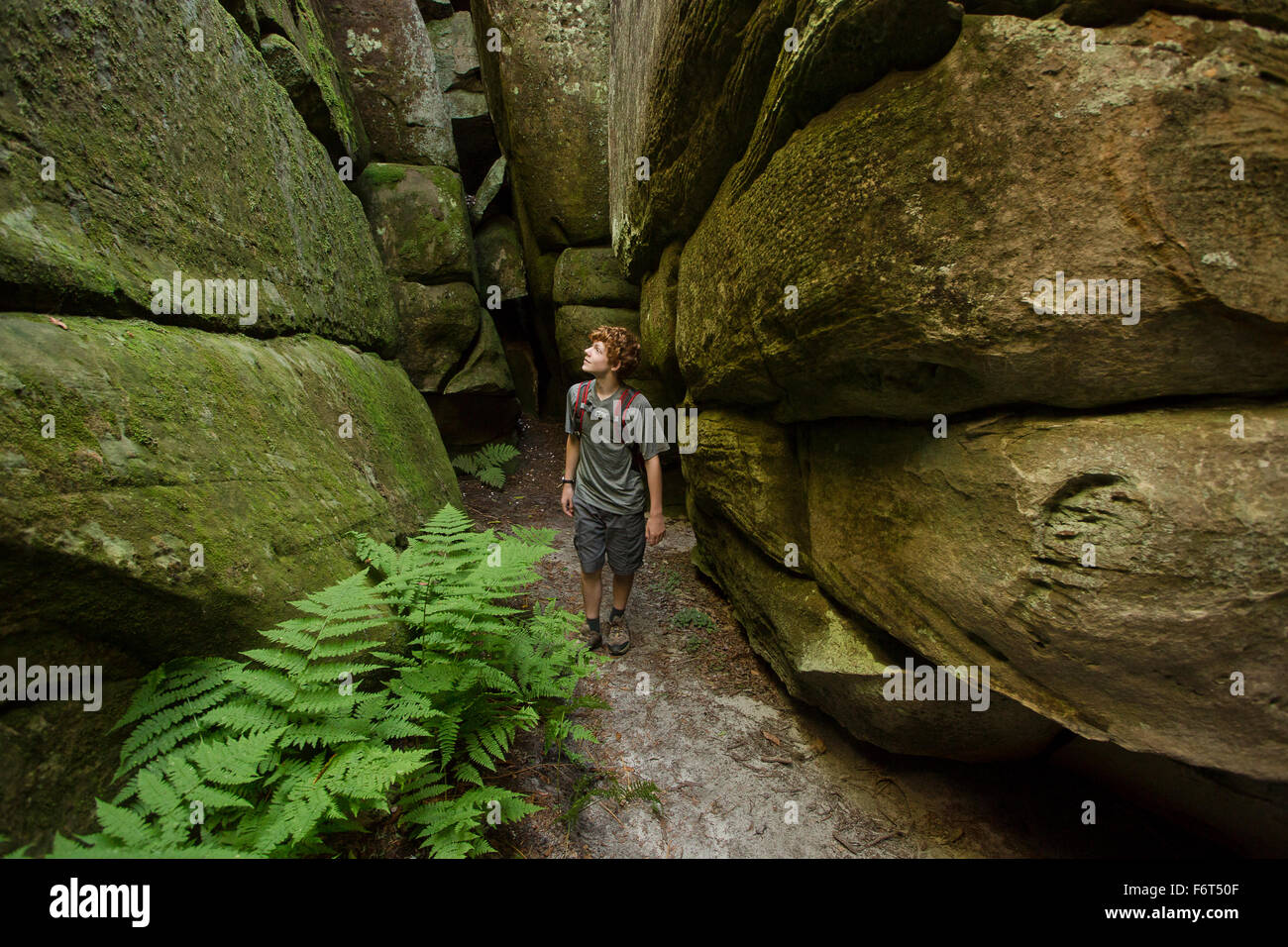 Caucasian teenage boy exploring cave Stock Photo - Alamy
