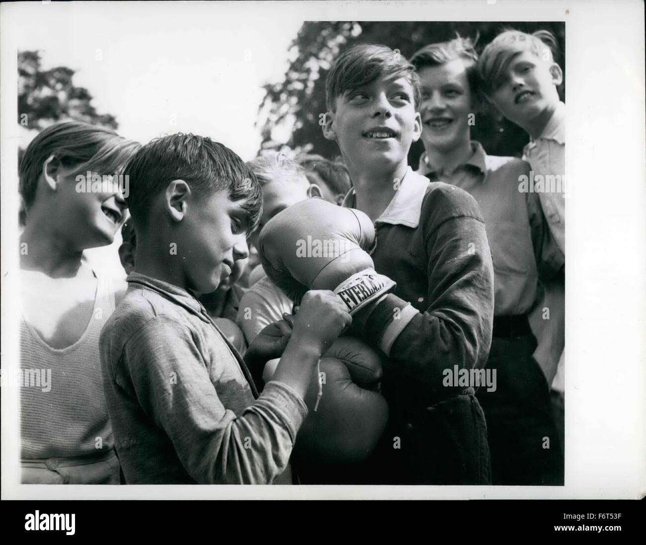 1948 - And in this corner: A German boy puts on the gloves for a ...