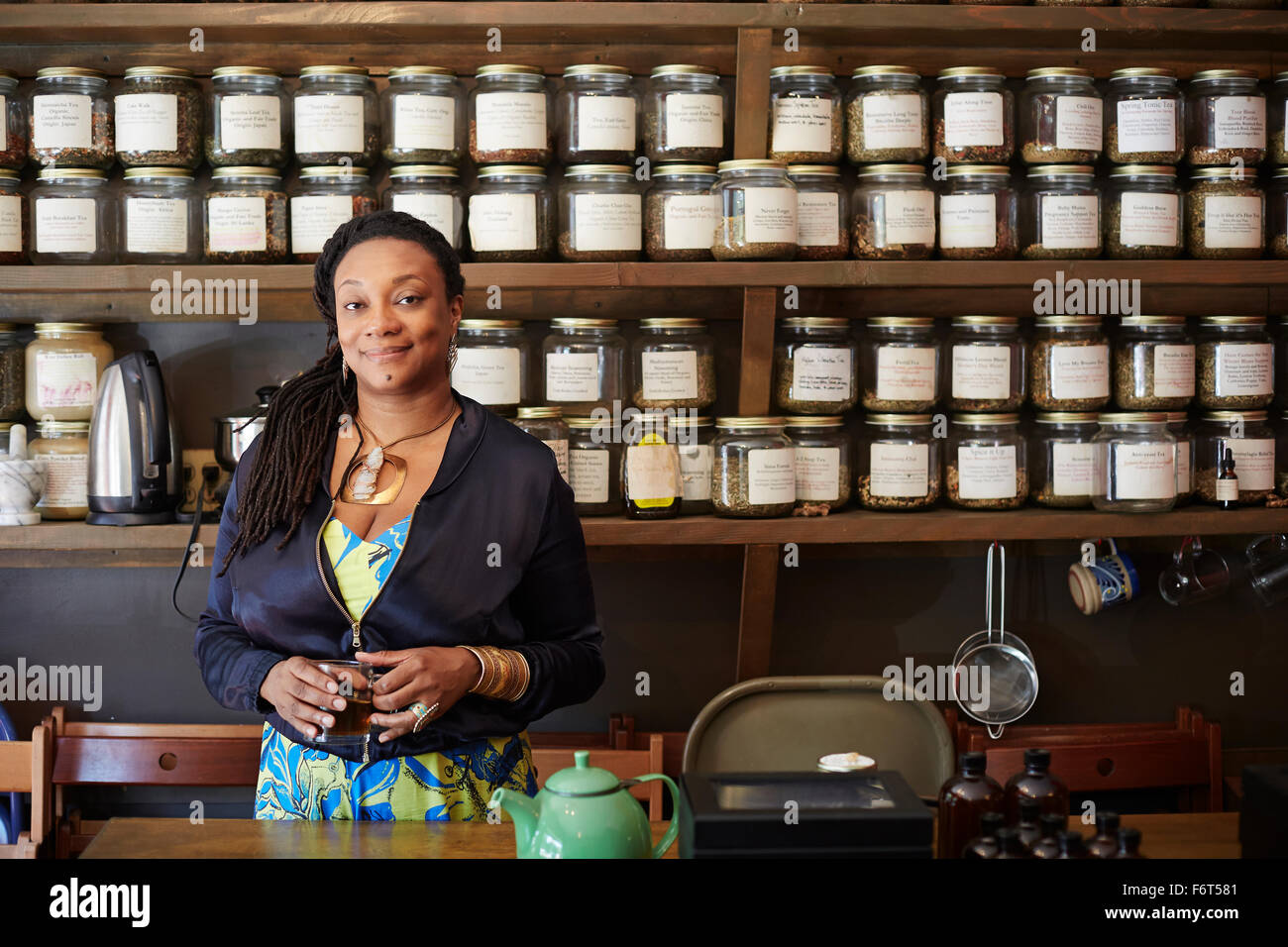 Black woman drinking tea in tea shop Stock Photo - Alamy