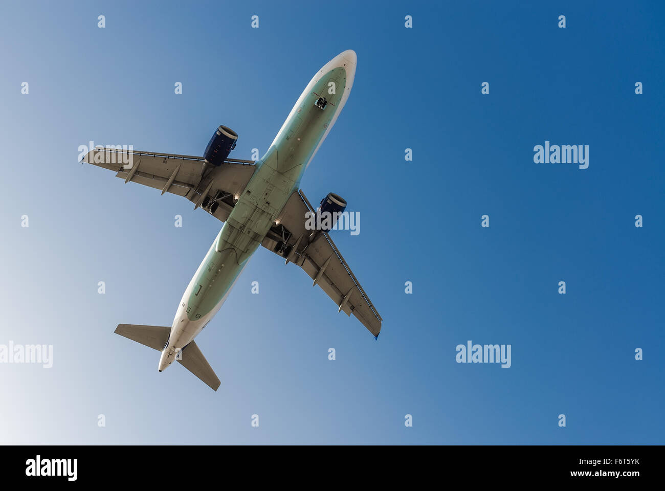 Airplane in the blue sky Stock Photo - Alamy