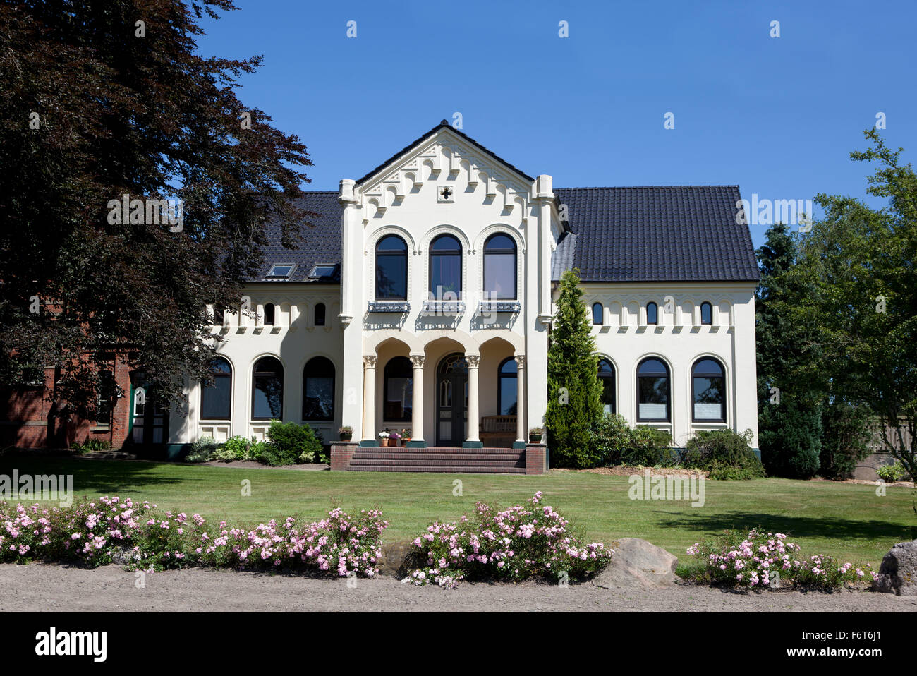a beautiful big white villa with flowers and trees Stock Photo - Alamy