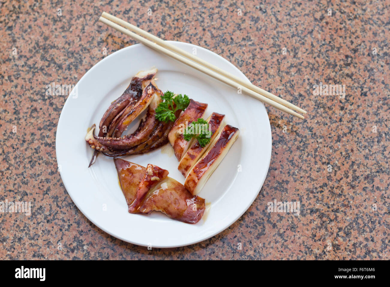 Marinated cooked squid calamari in sweet honey sauce Stock Photo - Alamy