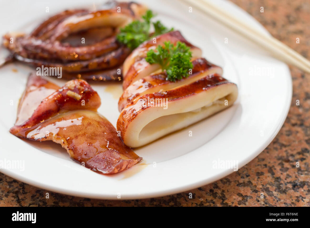 Marinated cooked squid calamari in sweet honey sauce Stock Photo - Alamy