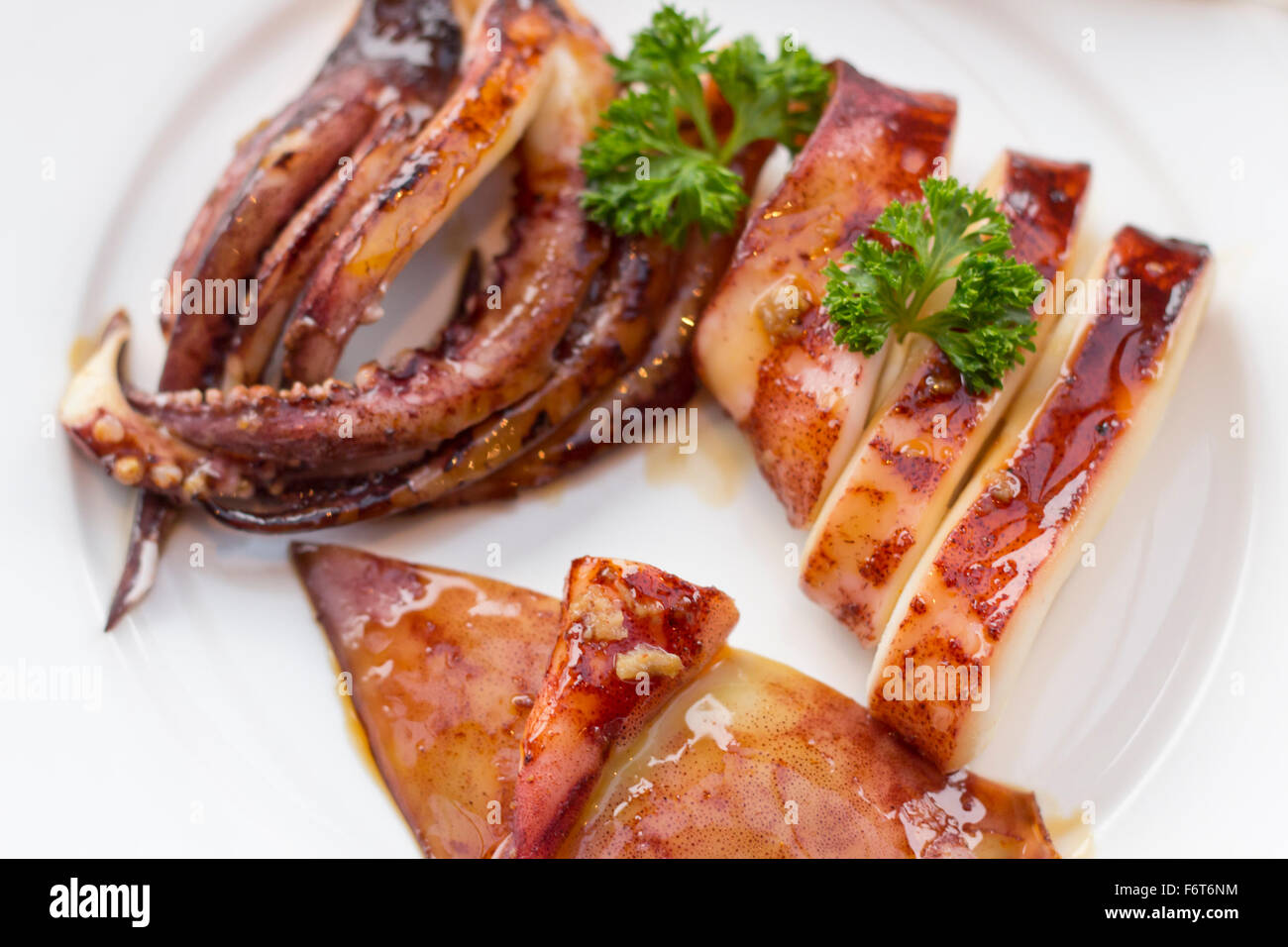 Marinated cooked squid calamari in sweet honey sauce Stock Photo - Alamy